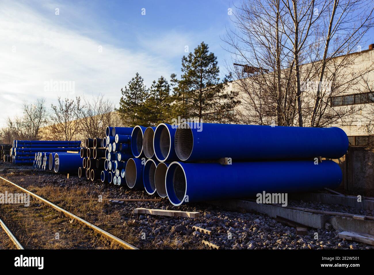 Stack of cast iron pipes in loading area waiting for transportation ...