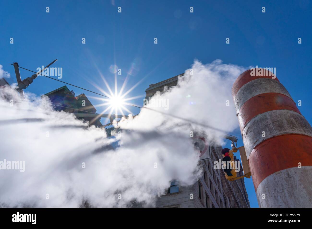 Steam rises and drifts in the blue sky around the Union Square NYC ...