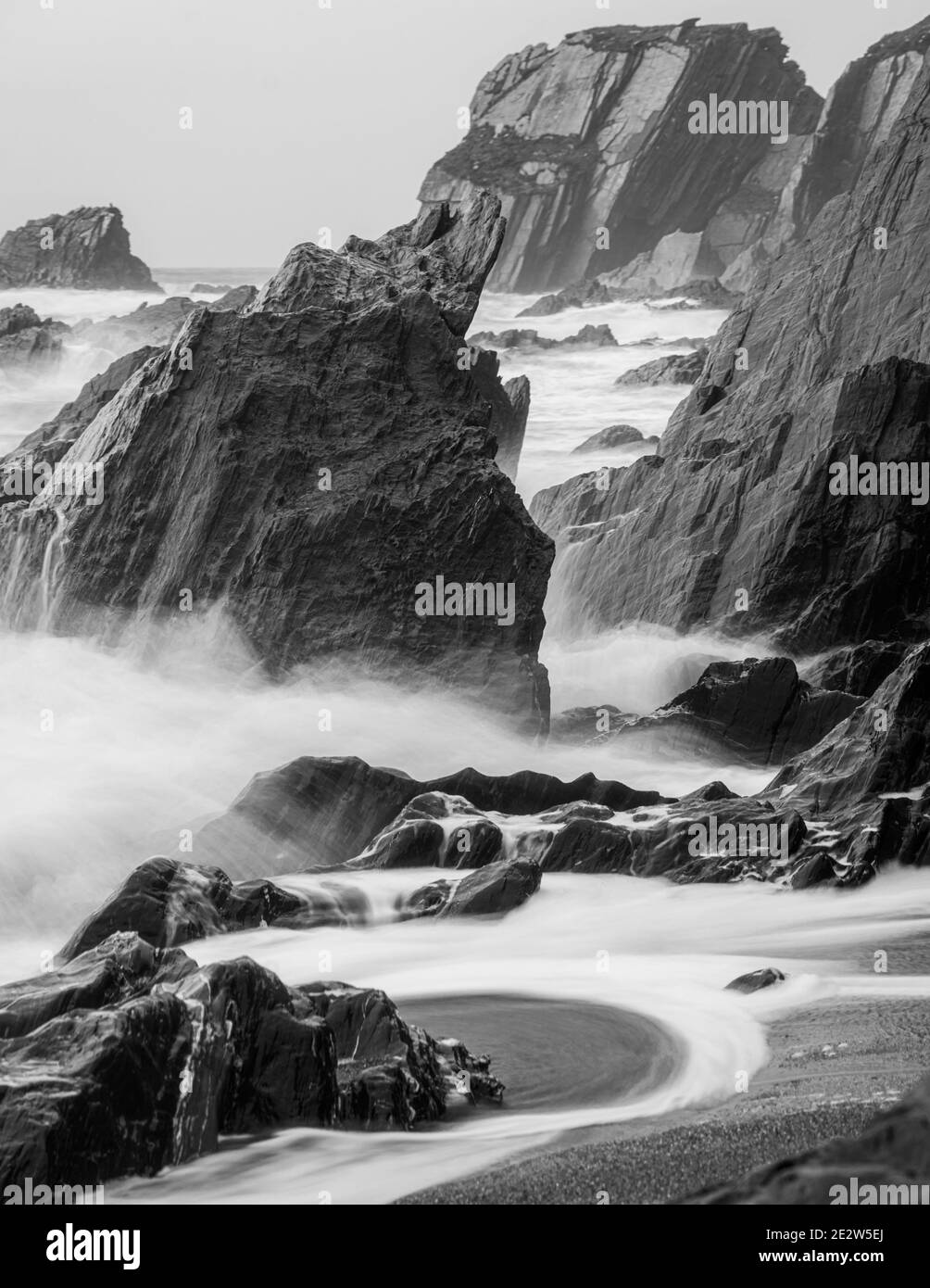Black and white image of the South Devon coast at Ayrmer Cove during a ...