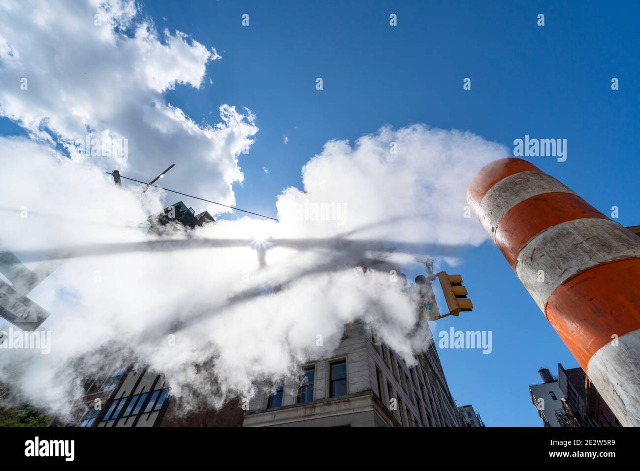 Steam rises and drifts in the blue sky around the Union Square NYC ...