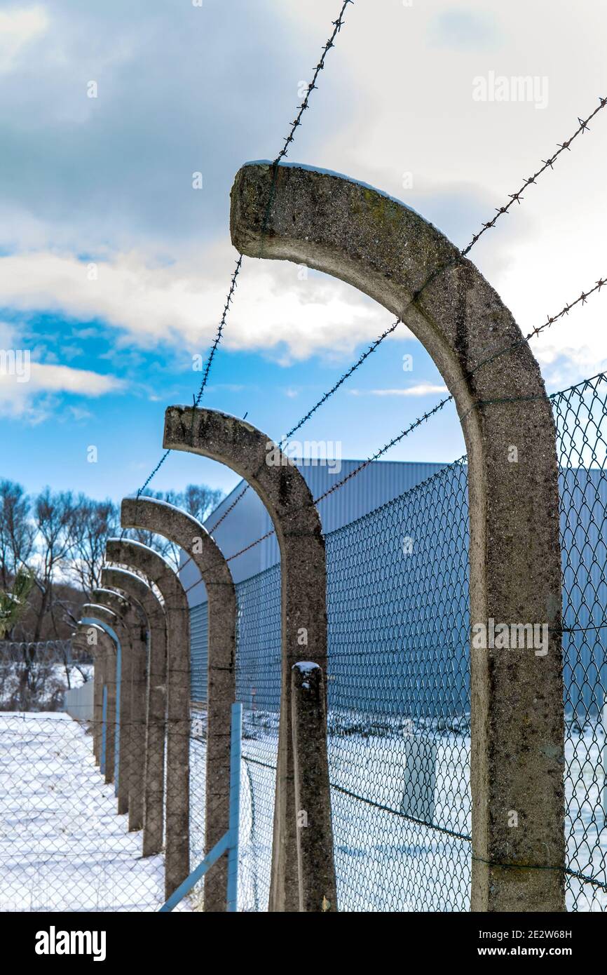 Restricted area - fence with barbed wire. Razor wire jail fence ...