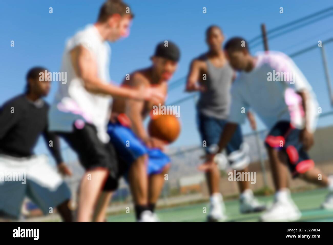 Group of multiethnic men playing basketball on court Stock Photo - Alamy