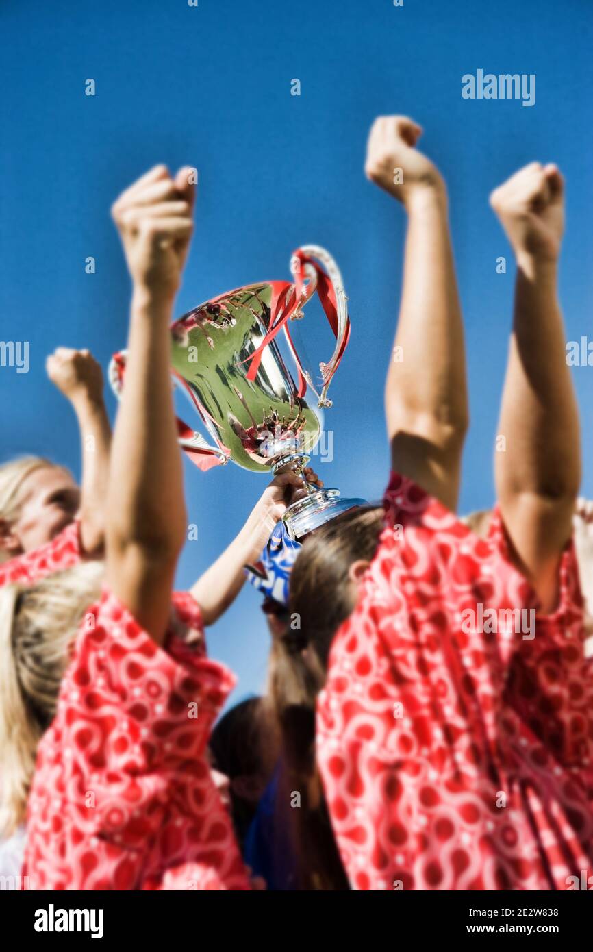 Girls with holding trophy and football hi-res stock photography and ...