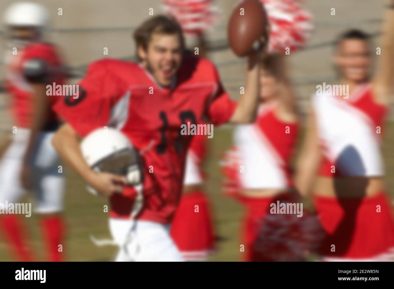 Happy Football Player Running by Cheerleaders Stock Photo - Alamy
