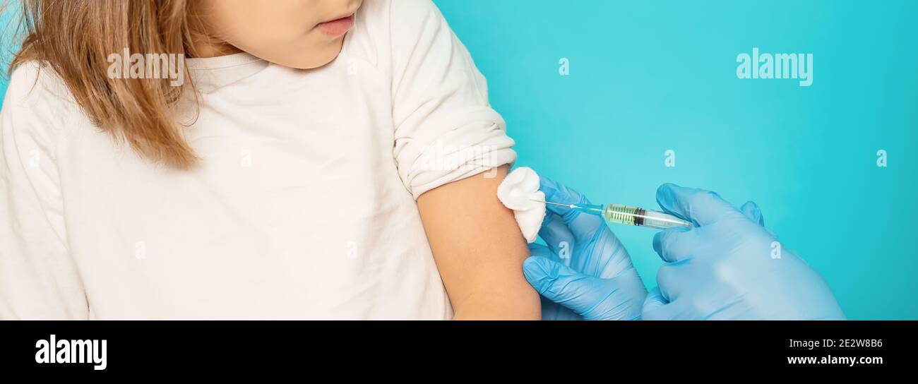 The child is injected into the arm. Selective focus Stock Photo - Alamy