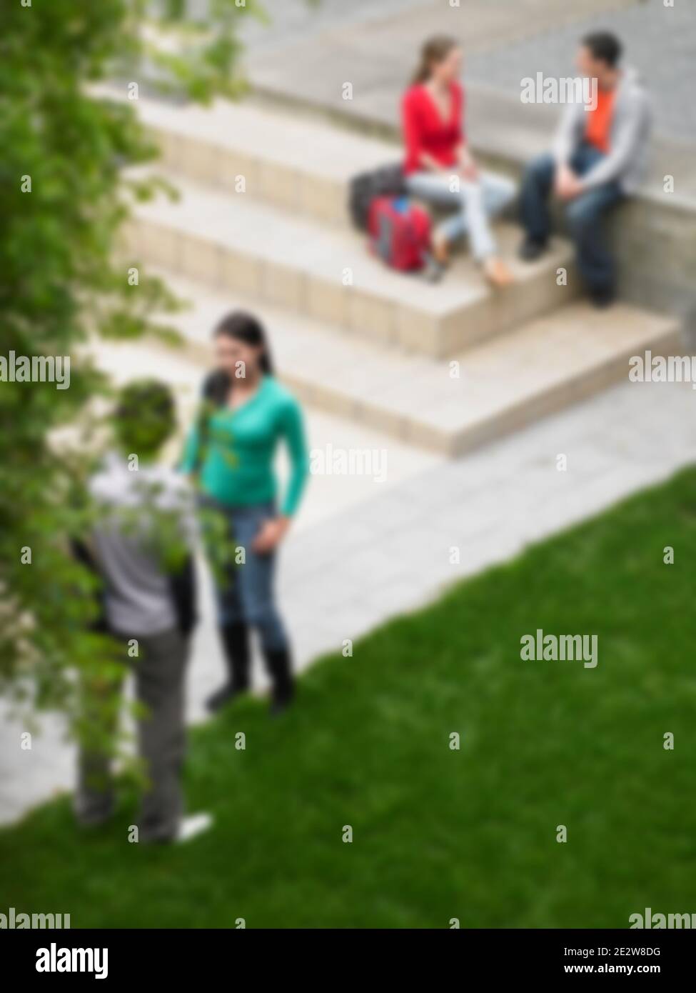 Blurred photo of teenage students in university campus Stock Photo - Alamy