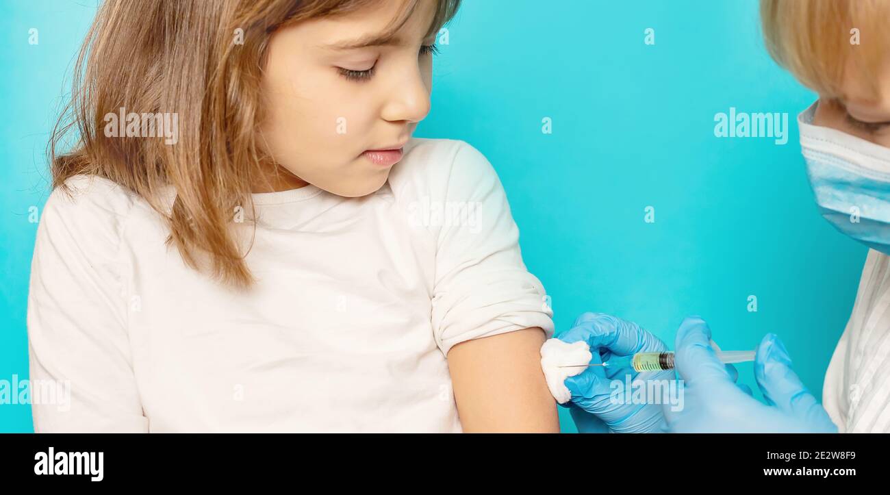 The child is injected into the arm. Selective focus Stock Photo - Alamy