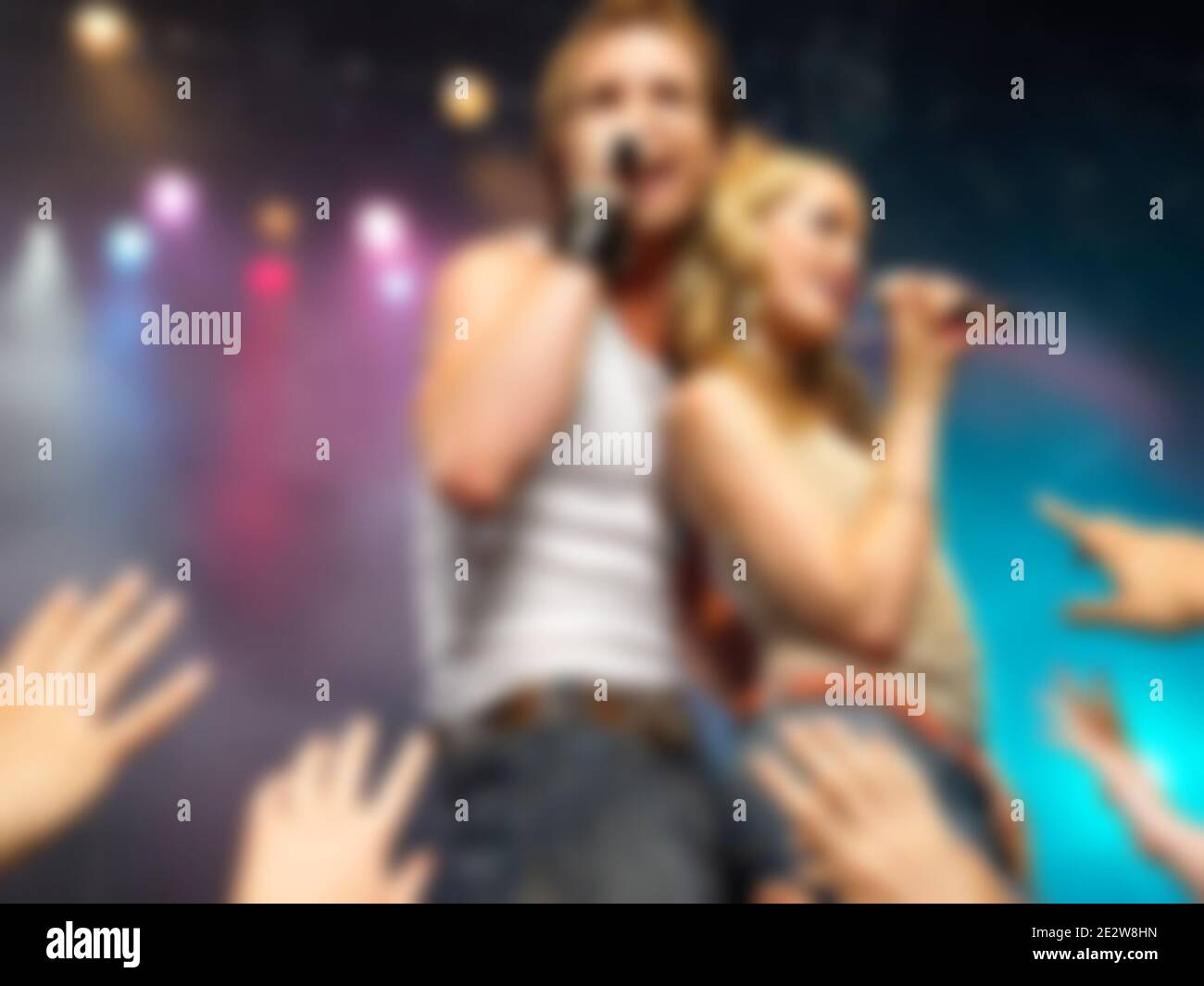 Blurred photo of female and male singer singing on stage Stock Photo ...