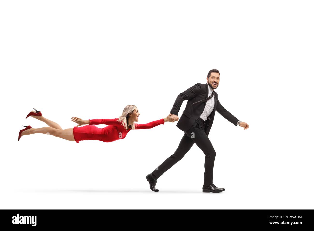 Man in a suit and tie running and pulling a flying woman in a red dress ...