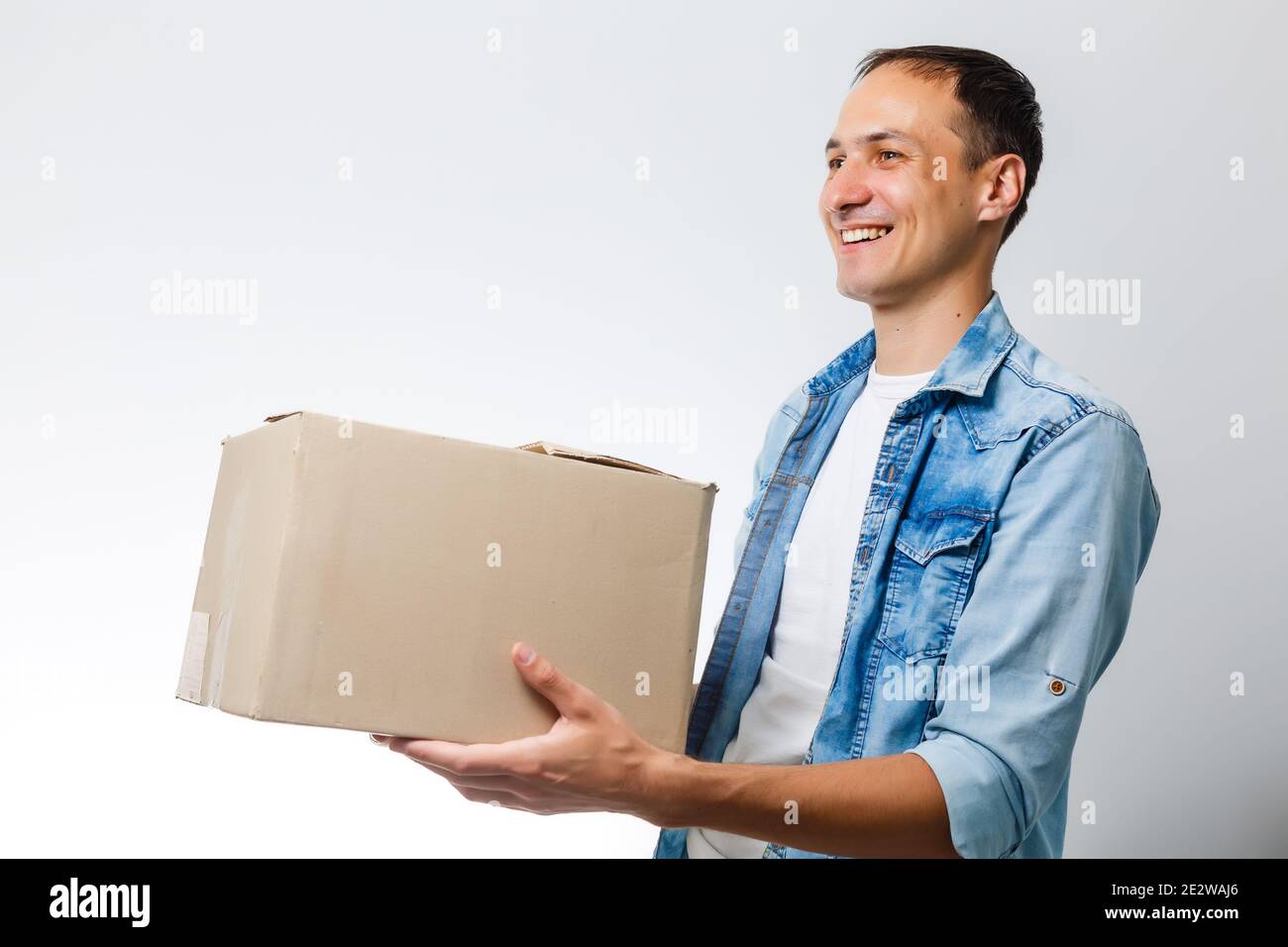 man carries the box, isolated, white background Stock Photo - Alamy