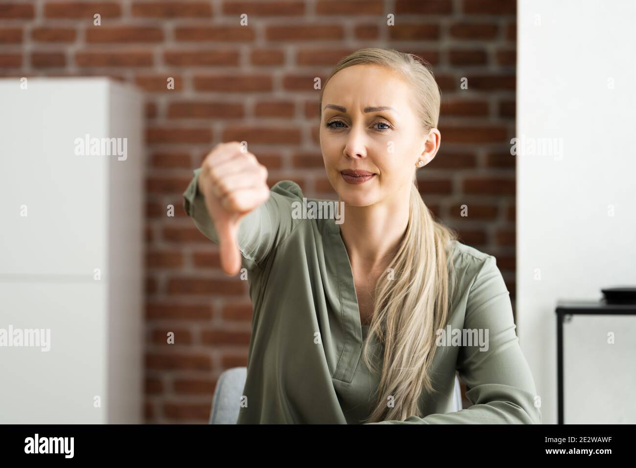 Women Giving Bad Feedback And Dislike Thumbs Down Stock Photo - Alamy