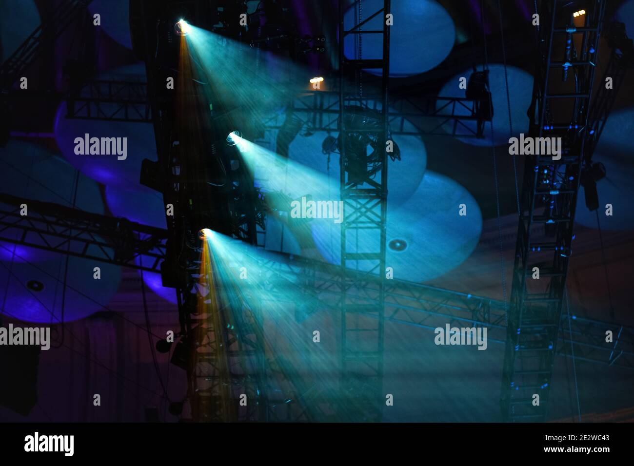 Blue reflector lights shining through smoke on theatre roof before ...