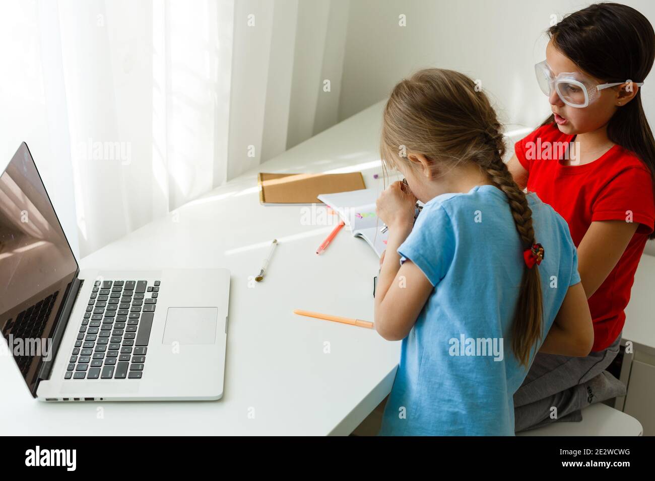 Cool online school. Kids studying online at home using a laptop ...