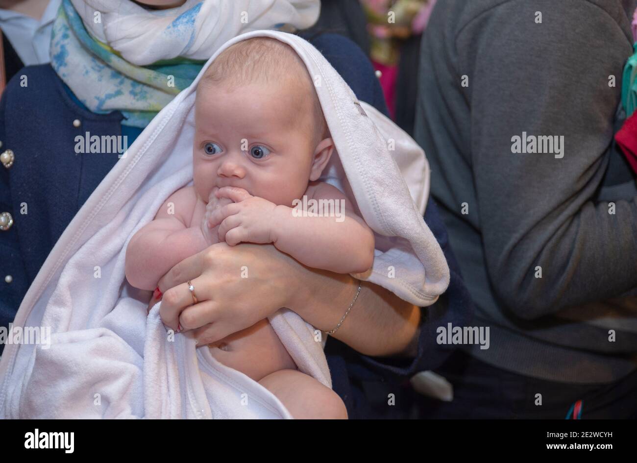 Little girl in towel after baptism ceremony Stock Photo - Alamy