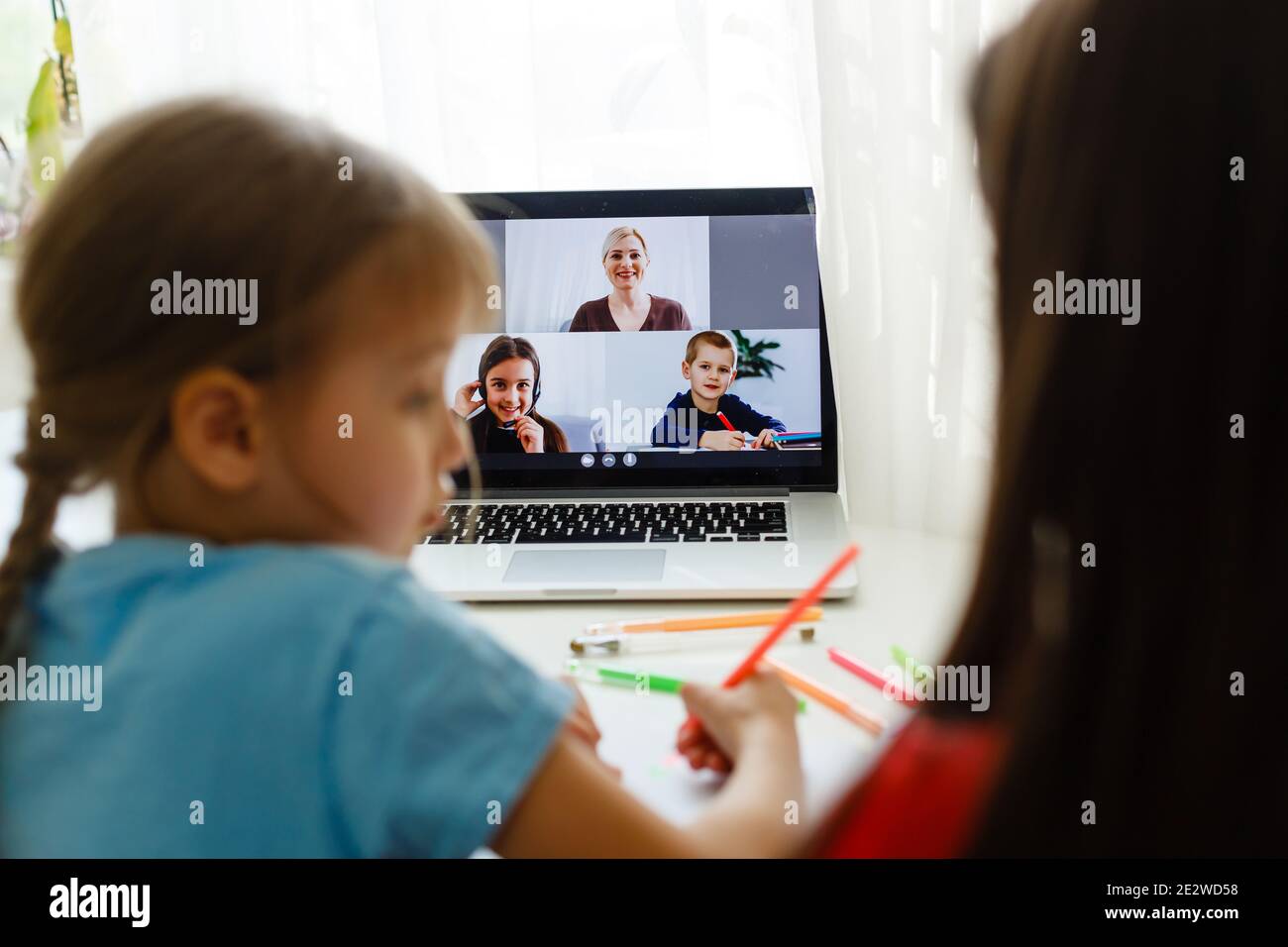Cool online school. Kids studying online at home using a laptop ...