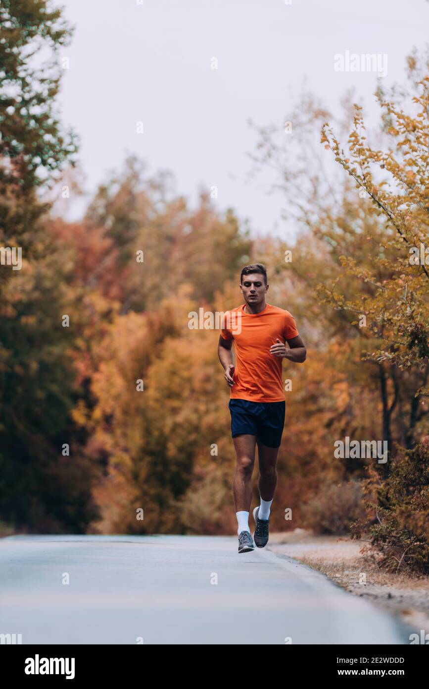 Fitness male sport fitness model sprinting outdoors on mountain path ...