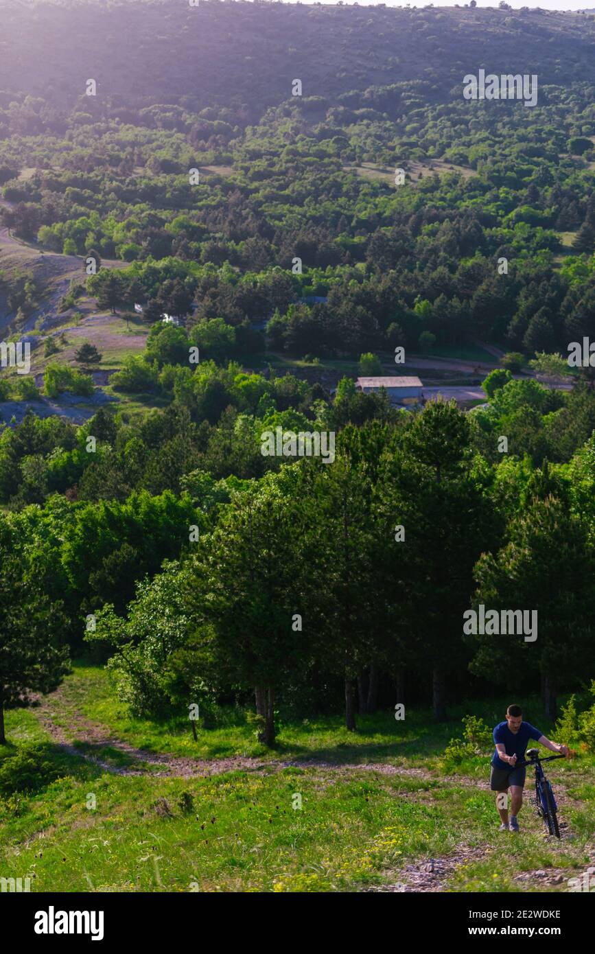 Downhill rider pushing bike hi-res stock photography and images - Alamy