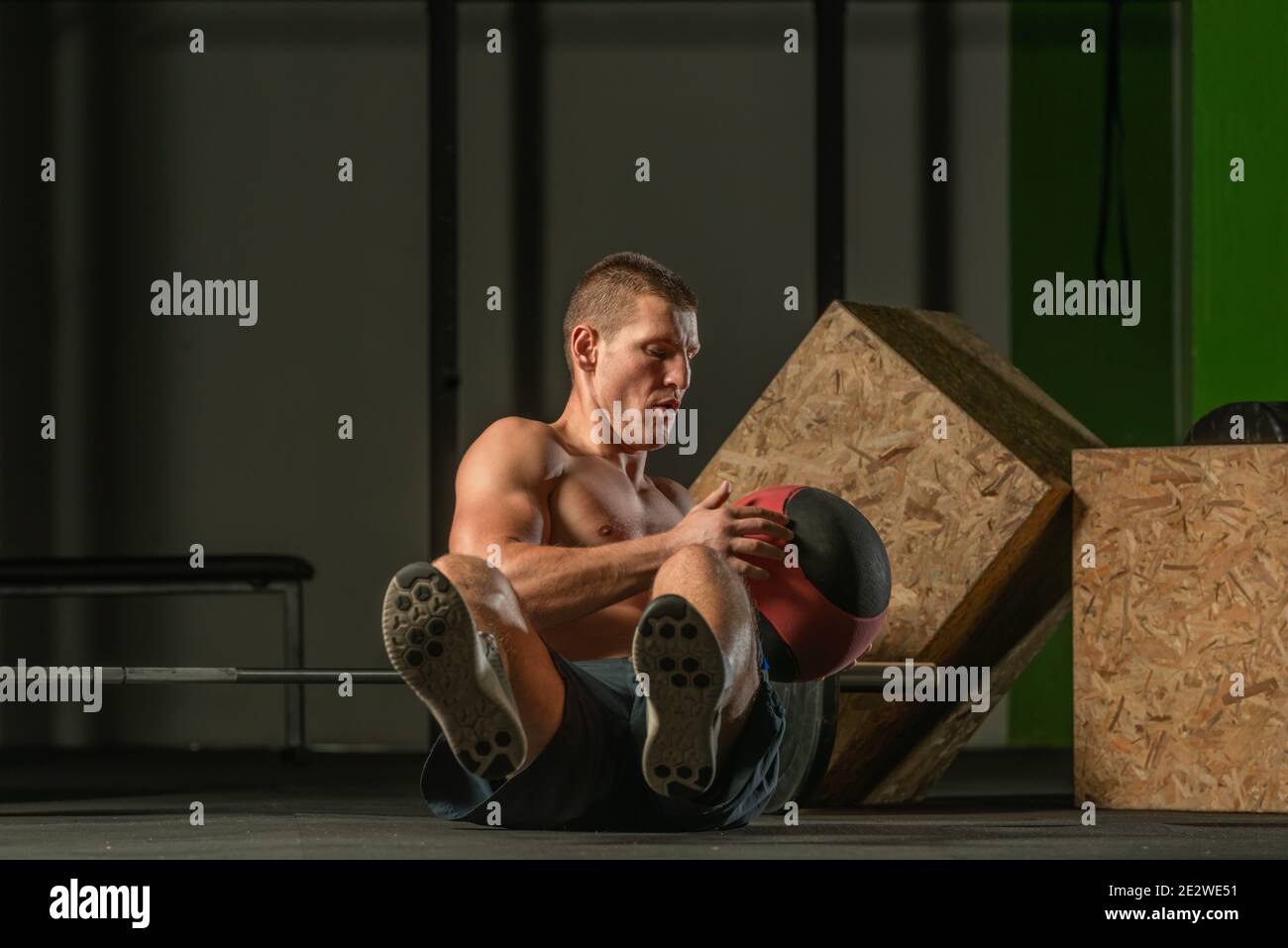 Close-up photo of a handsome bodybuilder working out seated using a ...