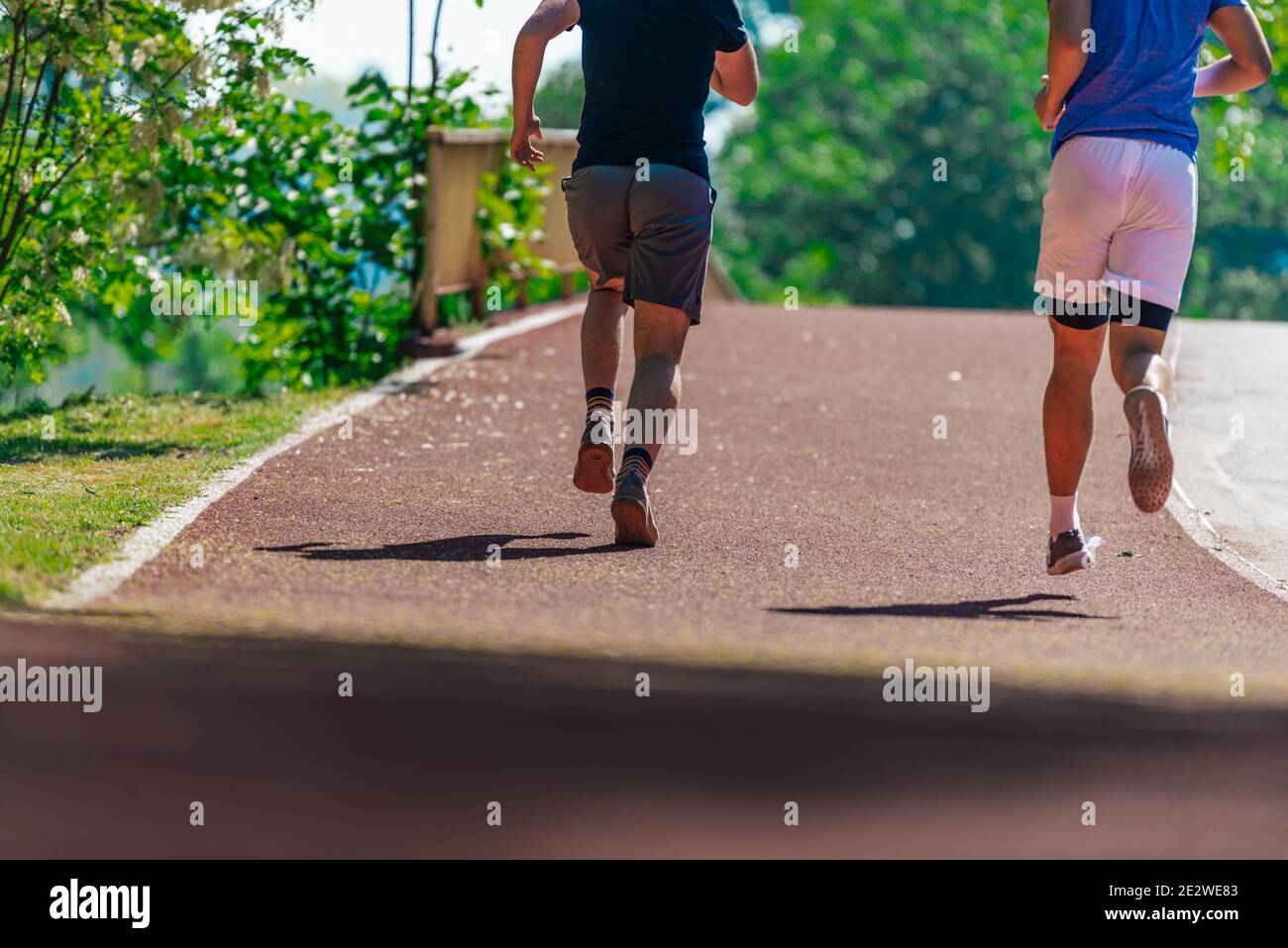 Close up feet with running shoes and strong athletic legs of sport man ...