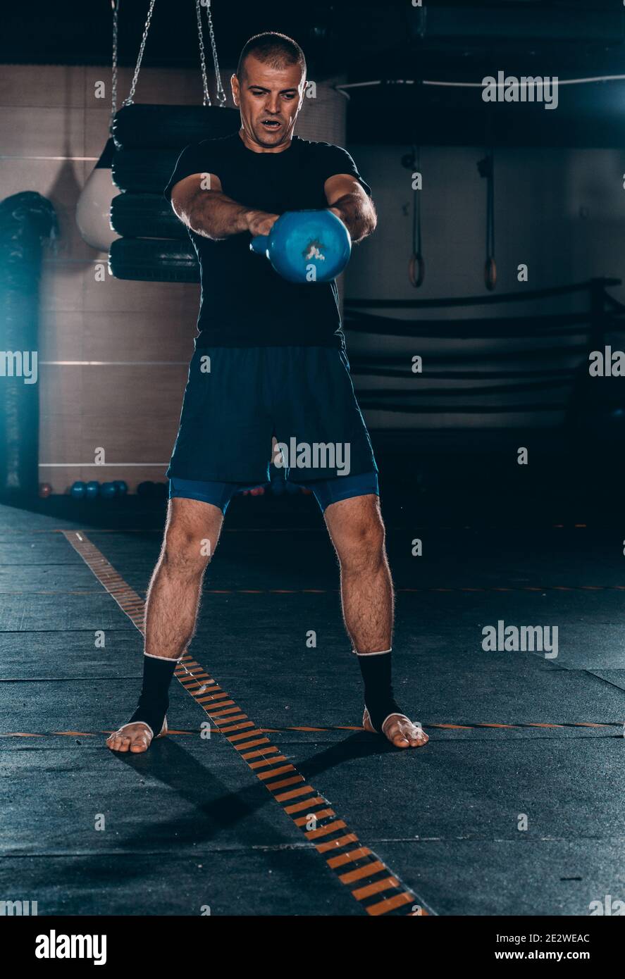 Strong man working out with kettlebell in modern gym Stock Photo - Alamy