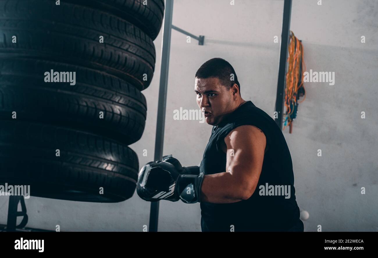 Boxer man during boxing hitting heavy bag at training fitness gym Stock ...