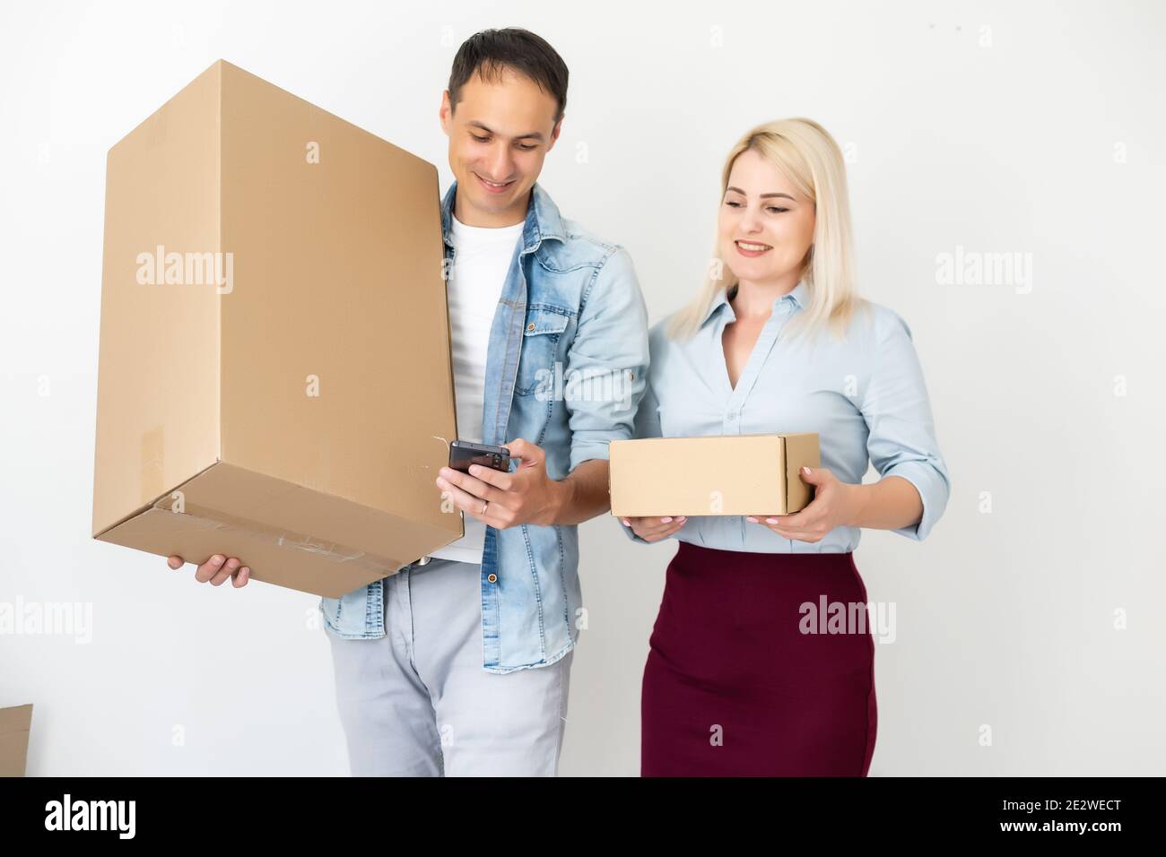 people, delivery, shipping and postal service concept - happy couple ...