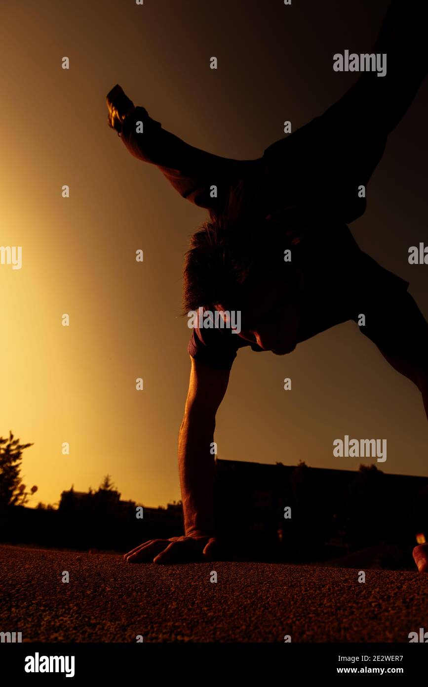 Handstand move performed by a young athletic guy at an urban area Stock ...