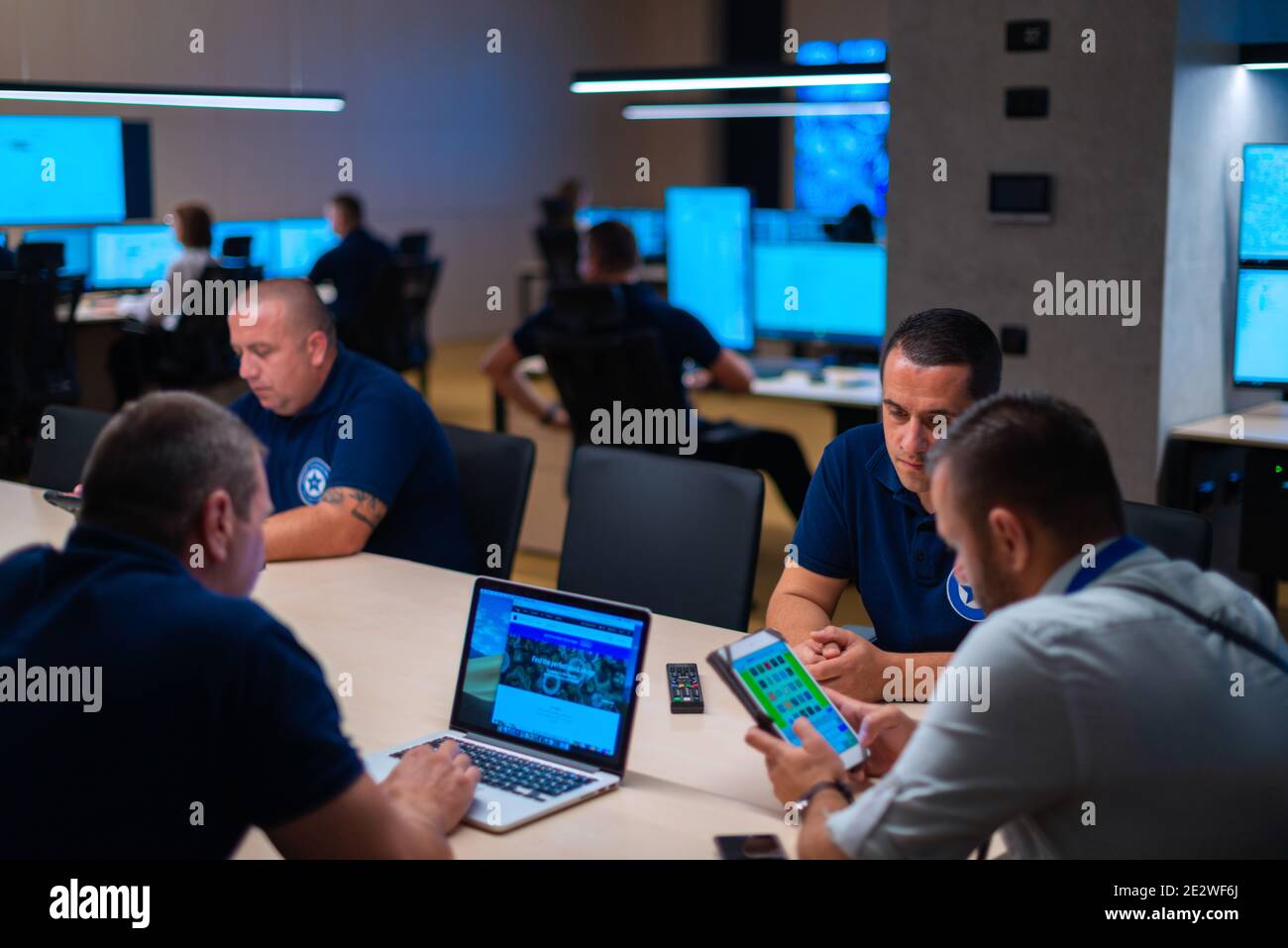 Group (security officers) tech guys meeting in a main security data ...