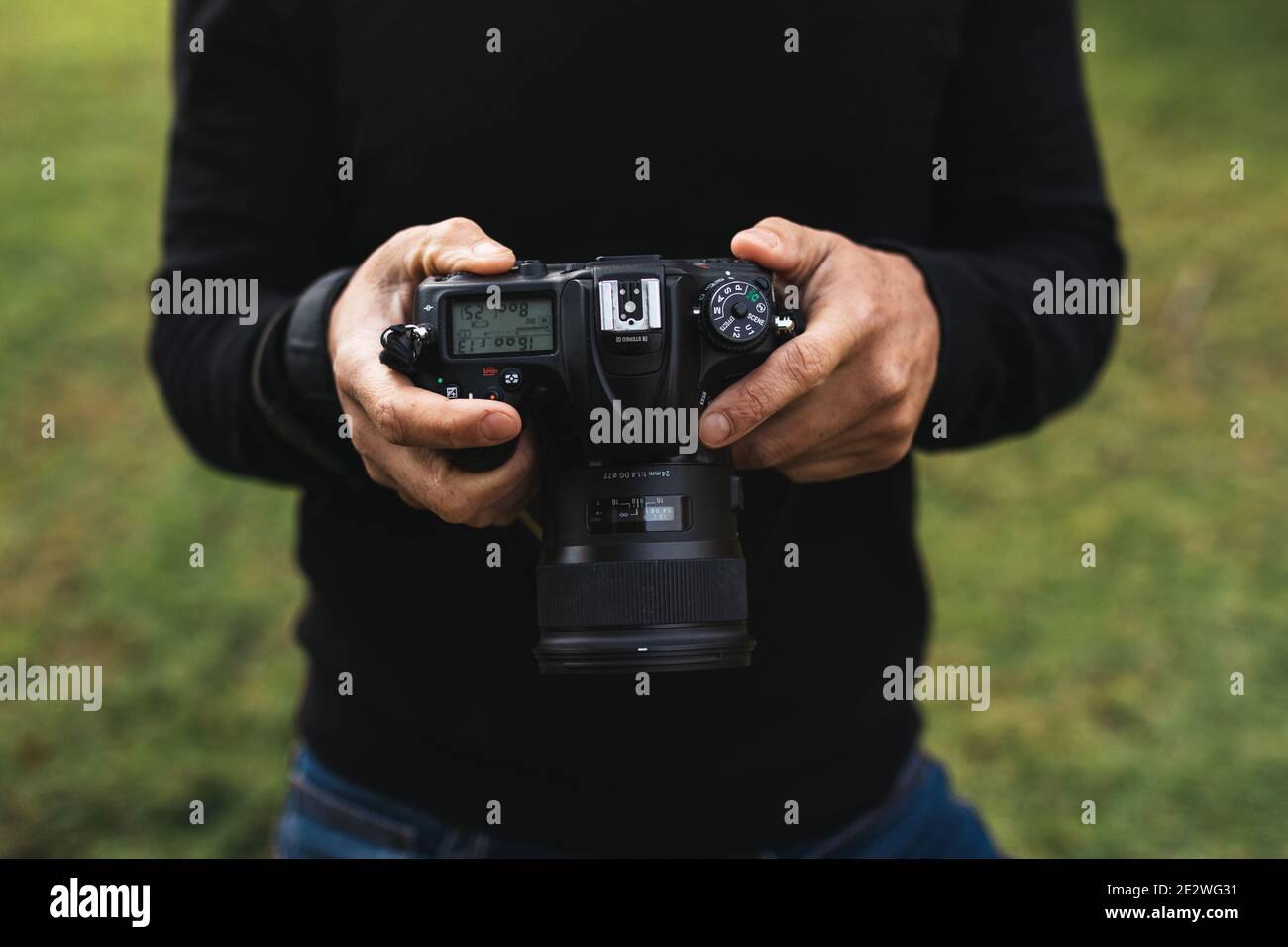 Shot Of A Man's Hands Holding A Camera Stock Photo - Alamy