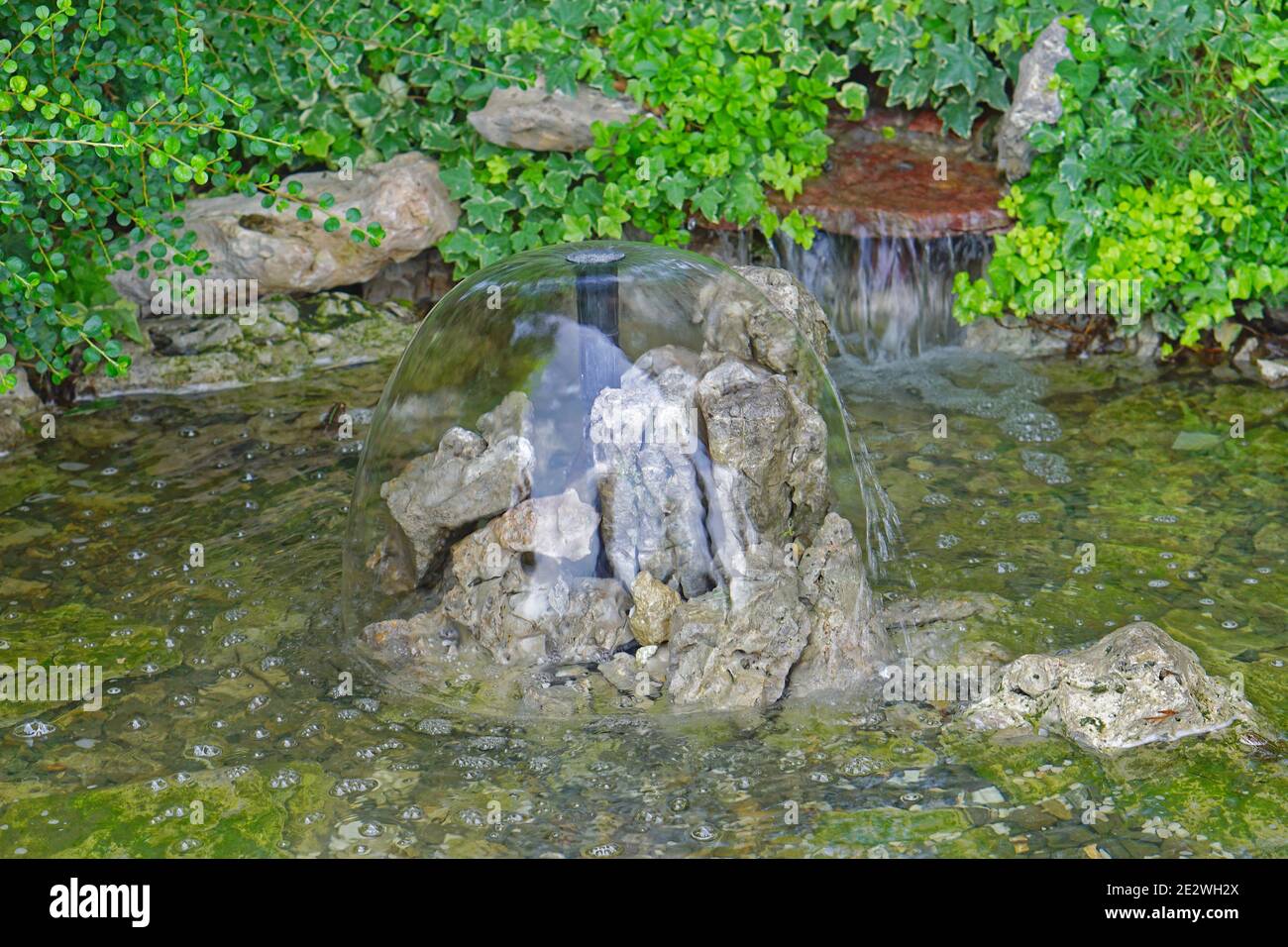 Small pond with waterfall in backyard decor Stock Photo - Alamy