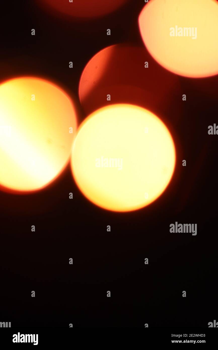 bokeh warm light on black background for overlay Stock Photo - Alamy