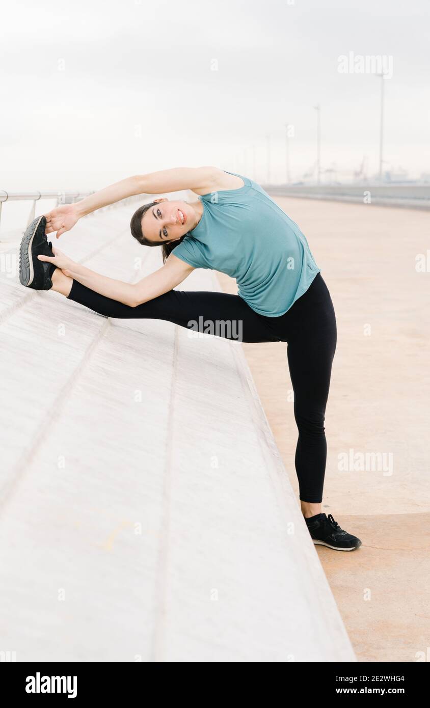 Girl practicing side stretch yoga posture Stock Photo - Alamy