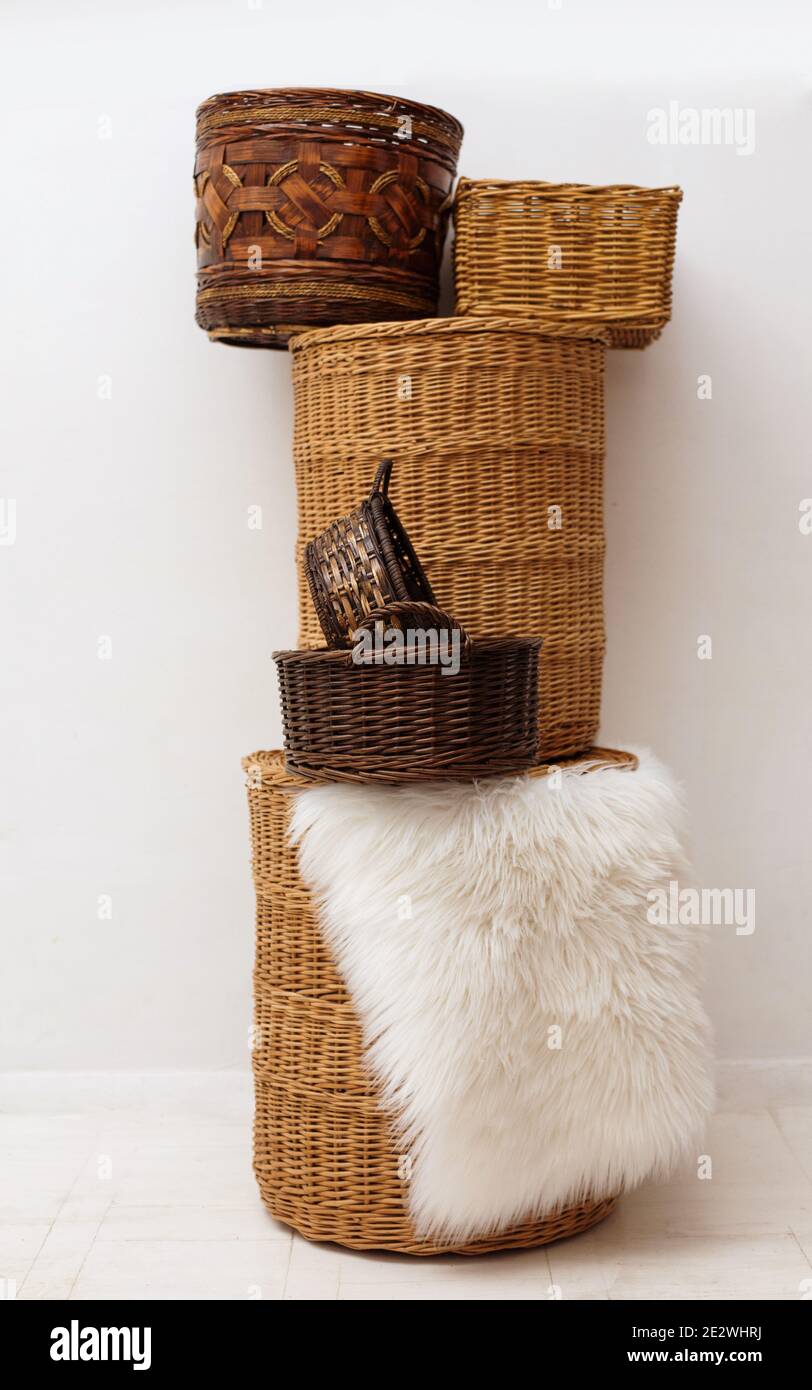 Stack of natural wicker straw cane bamboo baskets with fluffy carpet ...