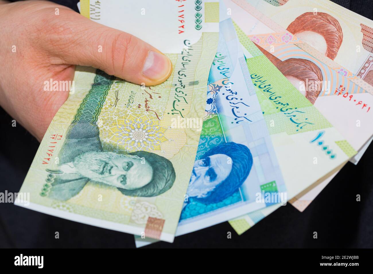 Iranian Riyal Money, Various Values, Banknotes spread out and held in ...