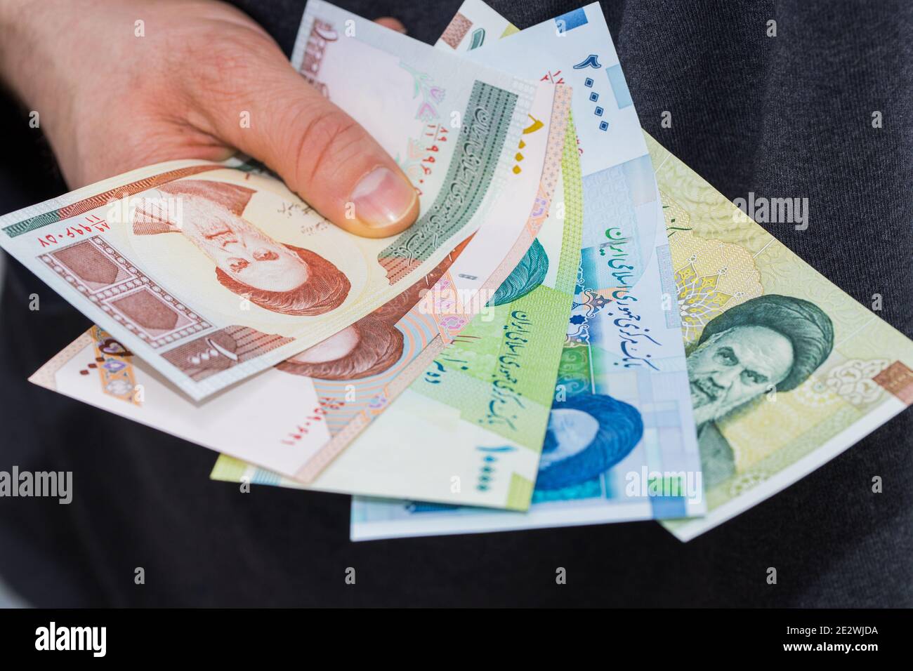 Iranian bills, Riyal, Assorted values, Money spread out and held in the ...