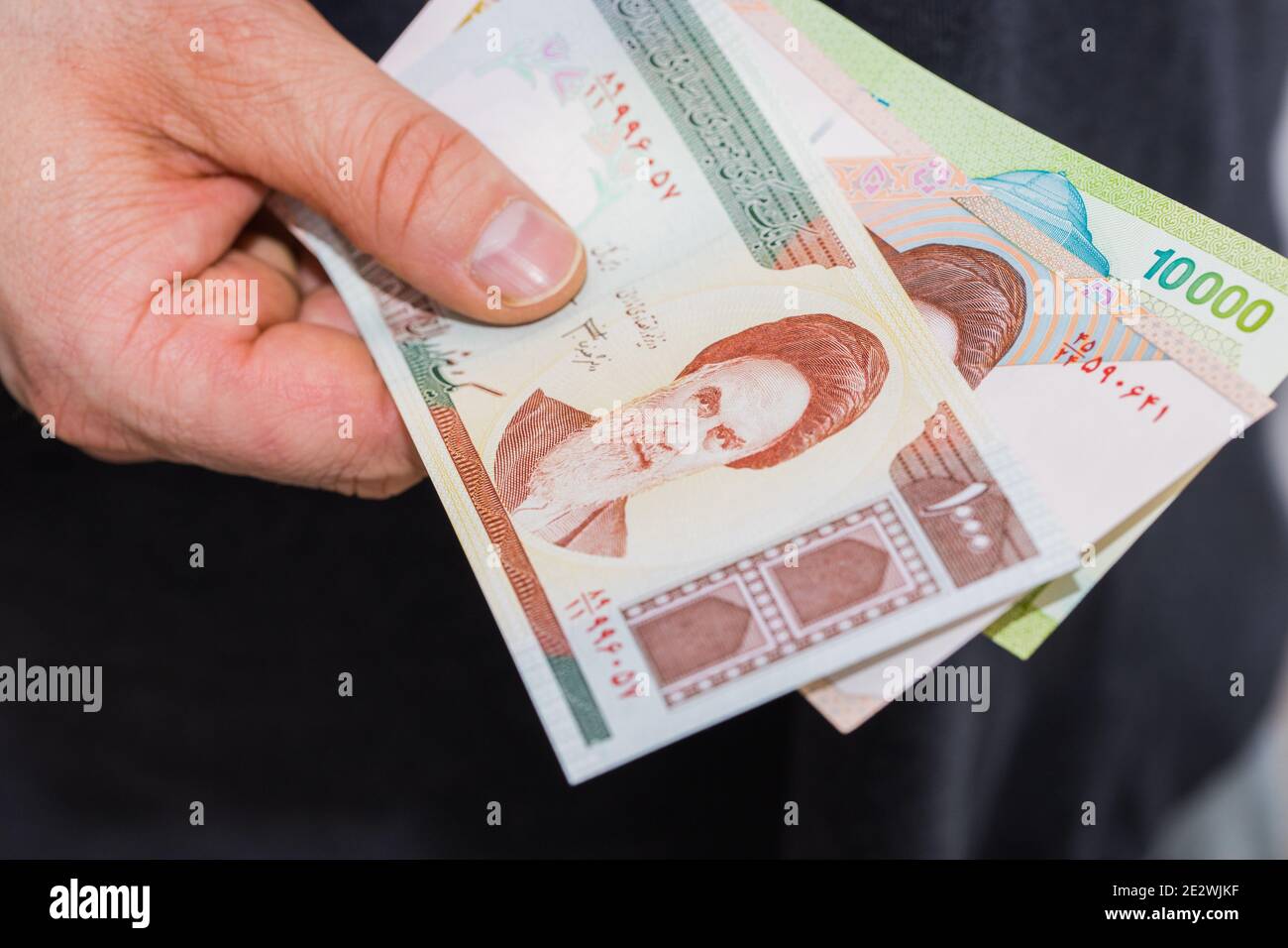 Iranian bills, Riyal, Assorted values, Money spread out and held in the ...