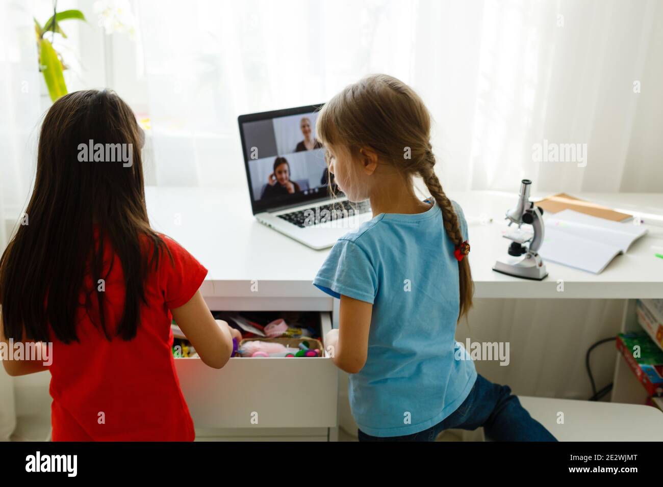 Cool online school. Kids studying online at home using a laptop ...