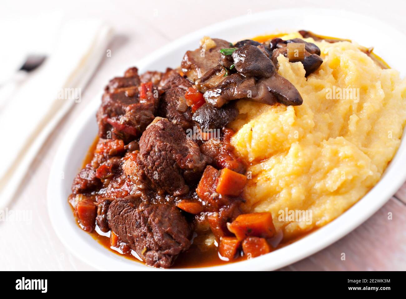 Delicious beef stew with mushrooms and polenta. High quality photo ...
