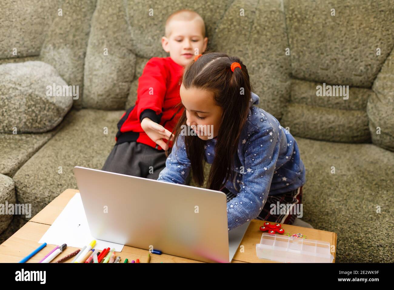 Distance learning online education. school boy and girl studying at ...
