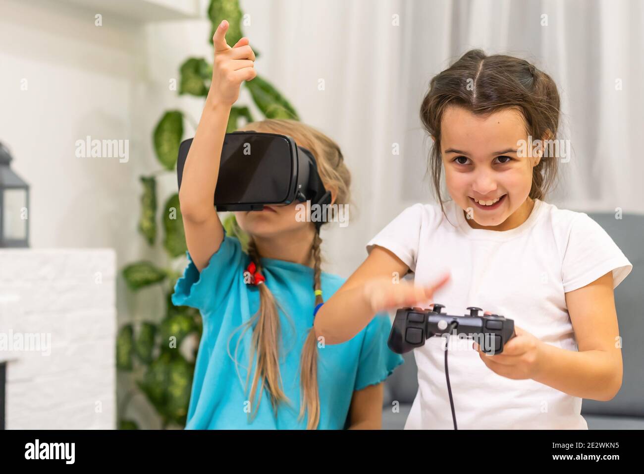 two little girls using glasses of virtual reality headset. concept of ...