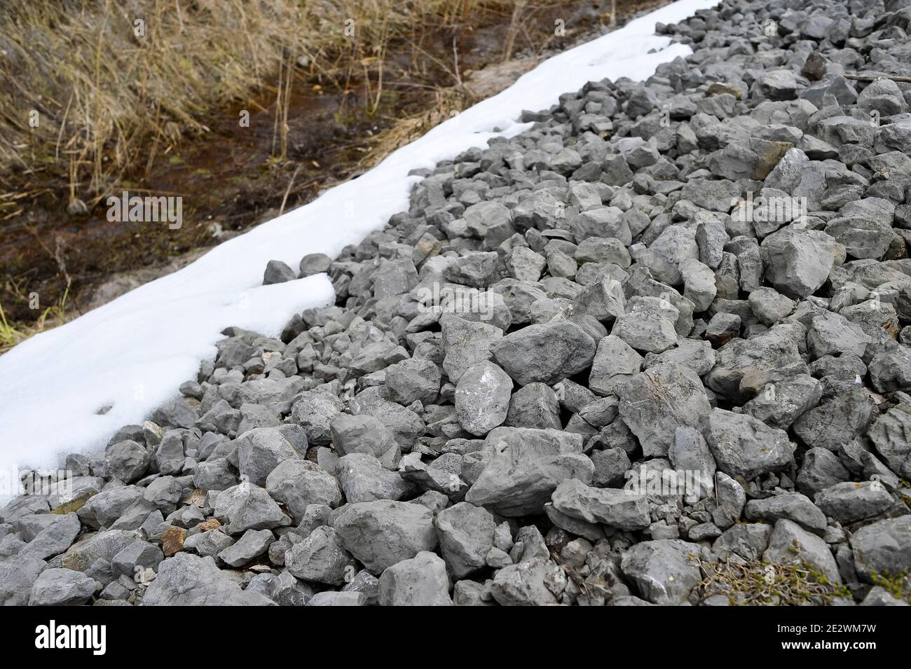 Gray natural rubble close-up on the dam against the background of the ...