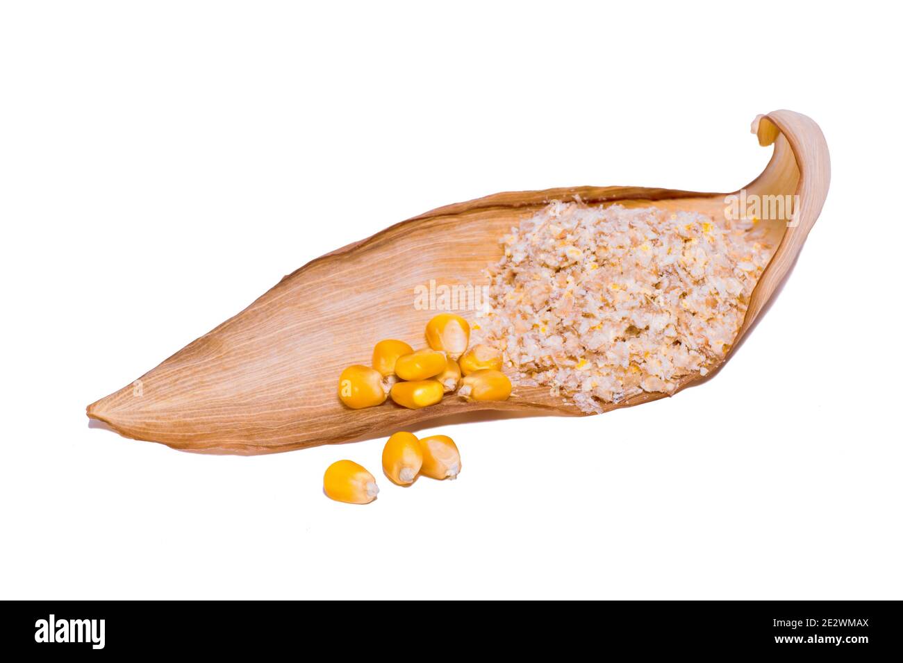 Corn bran with yellow corn kernels on a dry brown corn leaf cut on an ...
