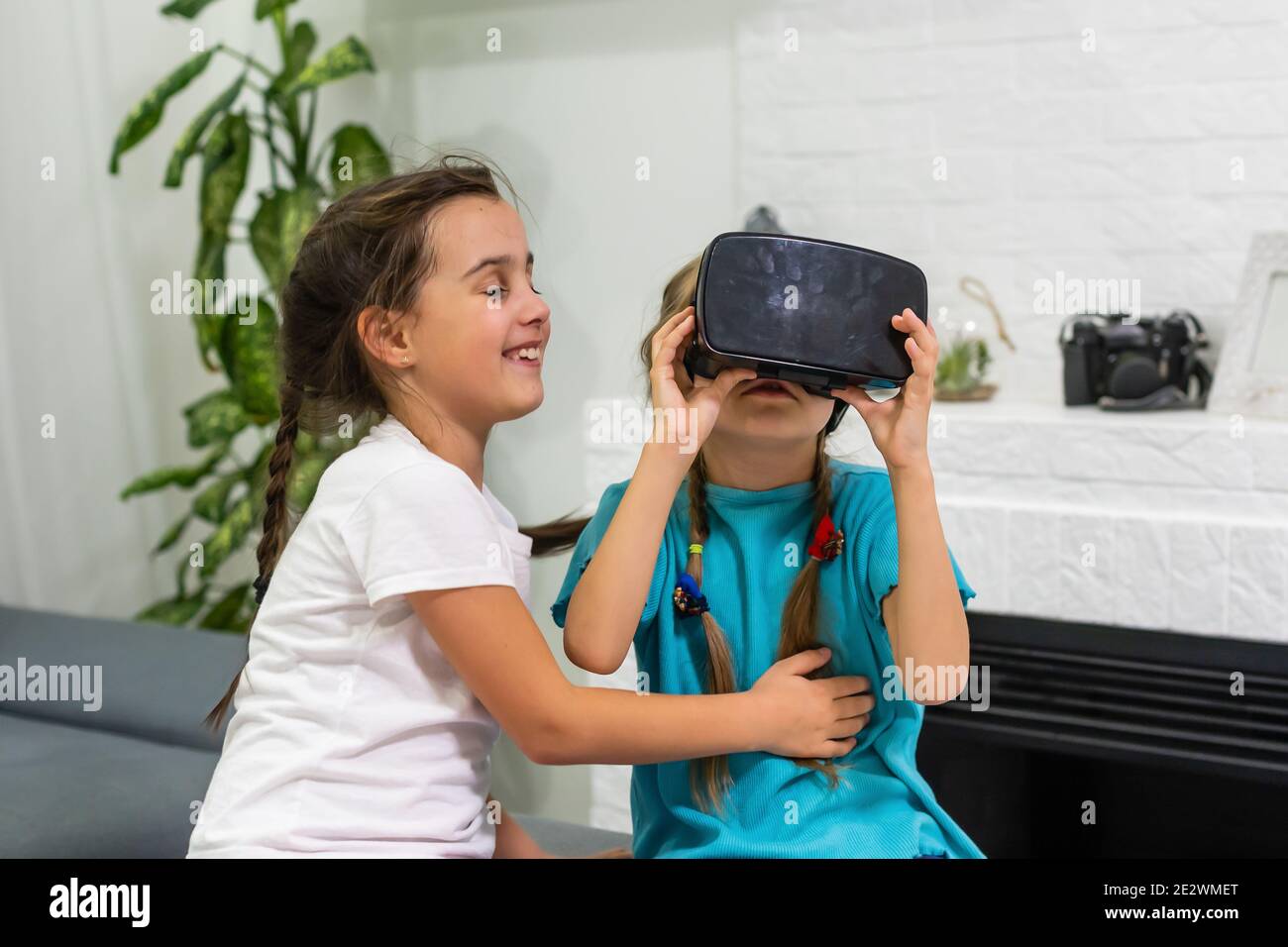 two little girls using glasses of virtual reality headset. concept of ...
