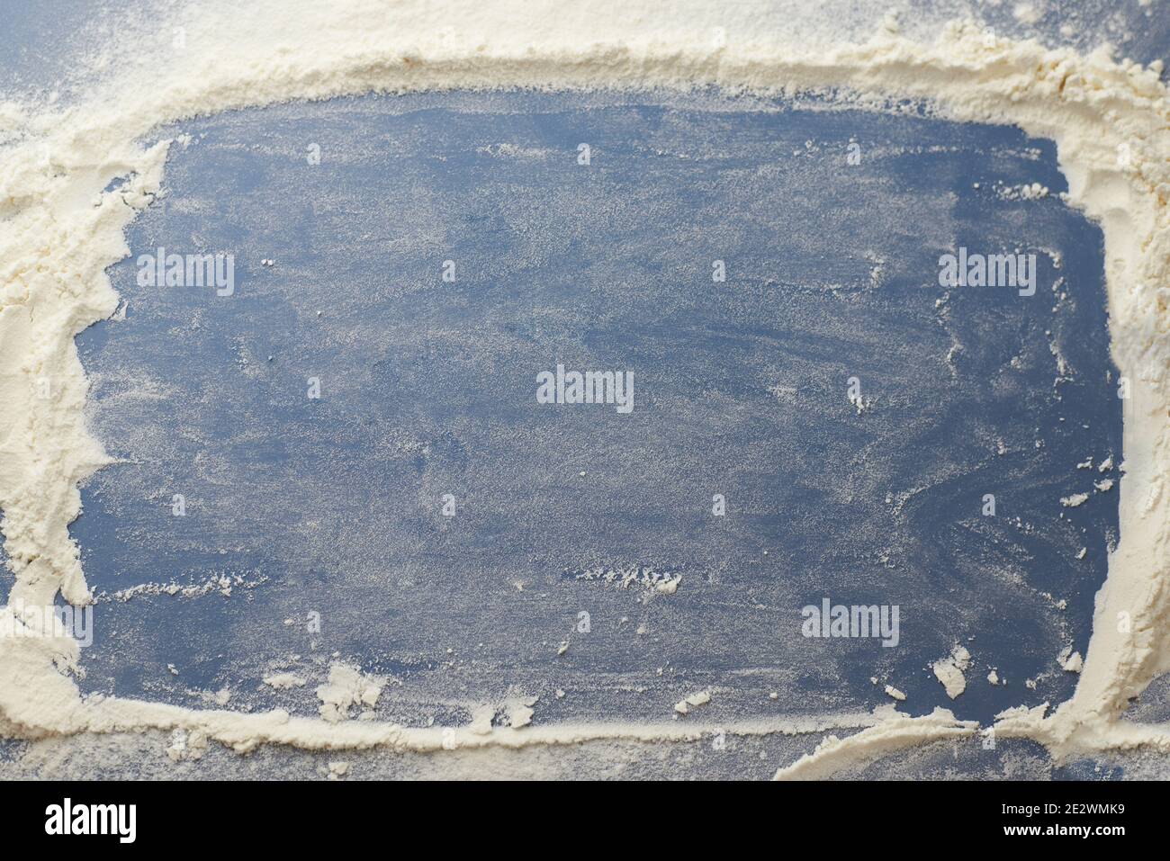 Smeared flour in frame on a blue background, creative background Stock ...