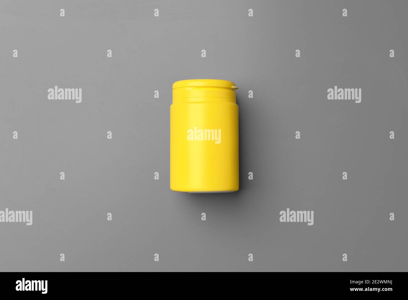 Yellow plastic container with lid on gray background Stock Photo - Alamy