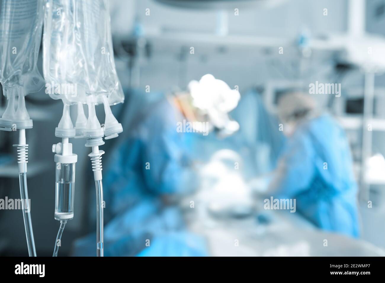 Intravenous system on the background of operating surgeons Stock Photo ...