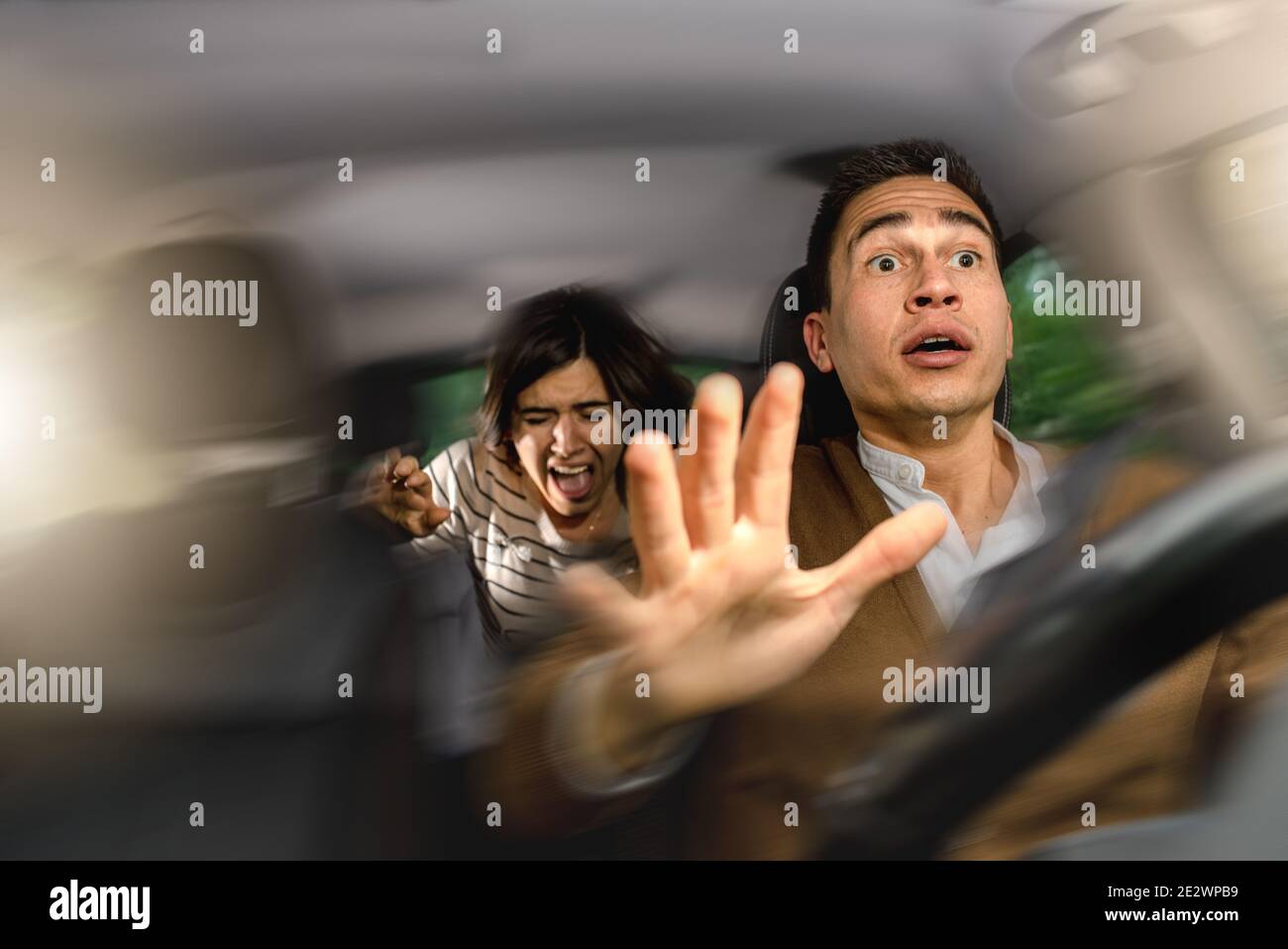 Scared passenger and a driver in the car during an accident Stock Photo ...