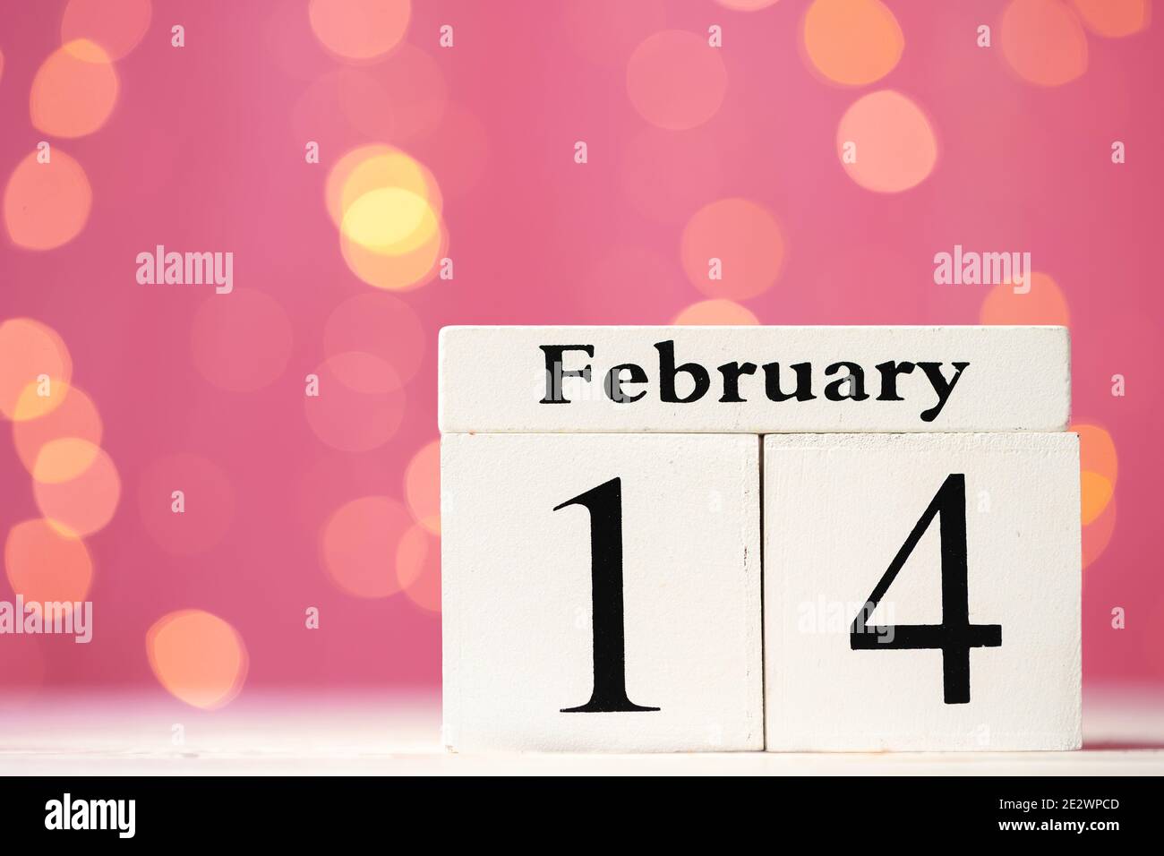 Wooden calendar 14th of February on pink bokeh background Stock Photo ...