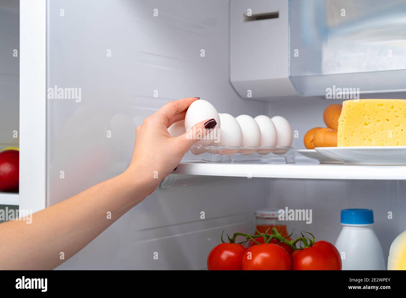 Female hand taking egg from a fridge Stock Photo - Alamy
