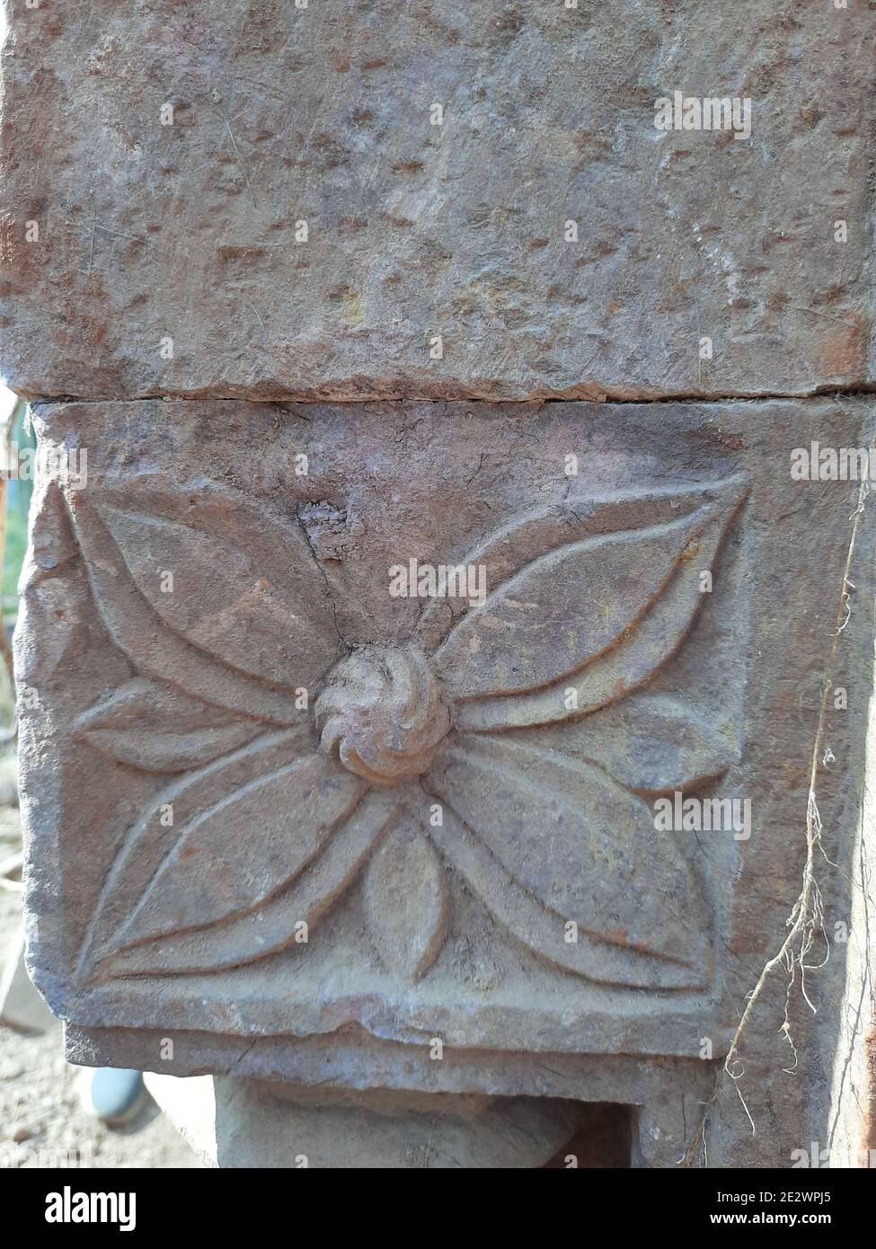 Vertical shot of a flower carving on a stone pillar Stock Photo - Alamy